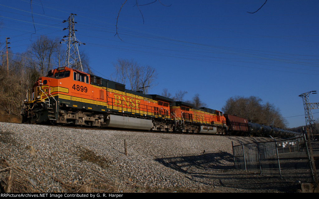 743 - Oil train K08025 with usual BNSF power below grade